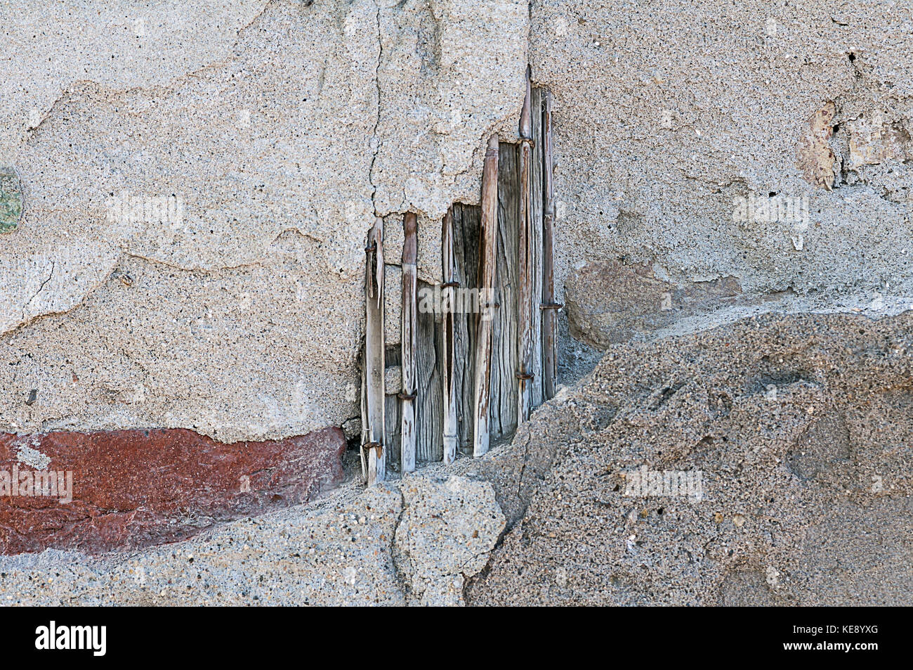 Brick wall. Broken plaster. Cracked and corroded cement. Hardened with ...