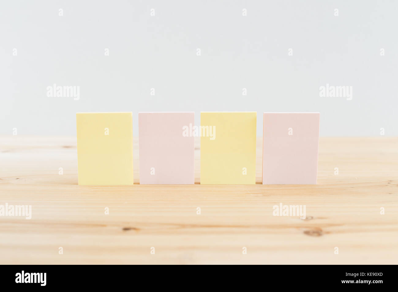 color blank sticky notes (post it) on wooden desk Stock Photo - Alamy