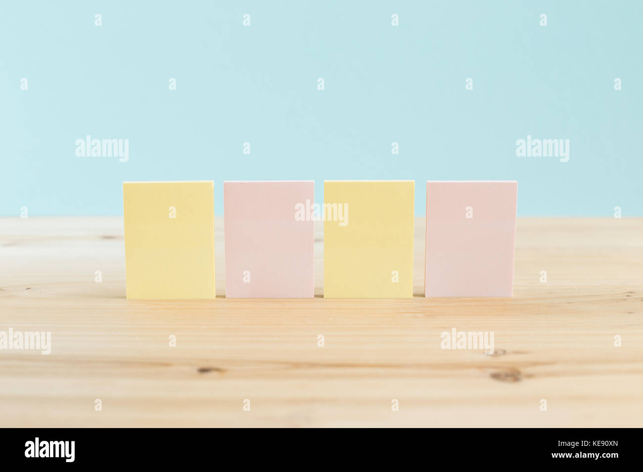 color blank sticky notes (post it) on wooden desk Stock Photo - Alamy