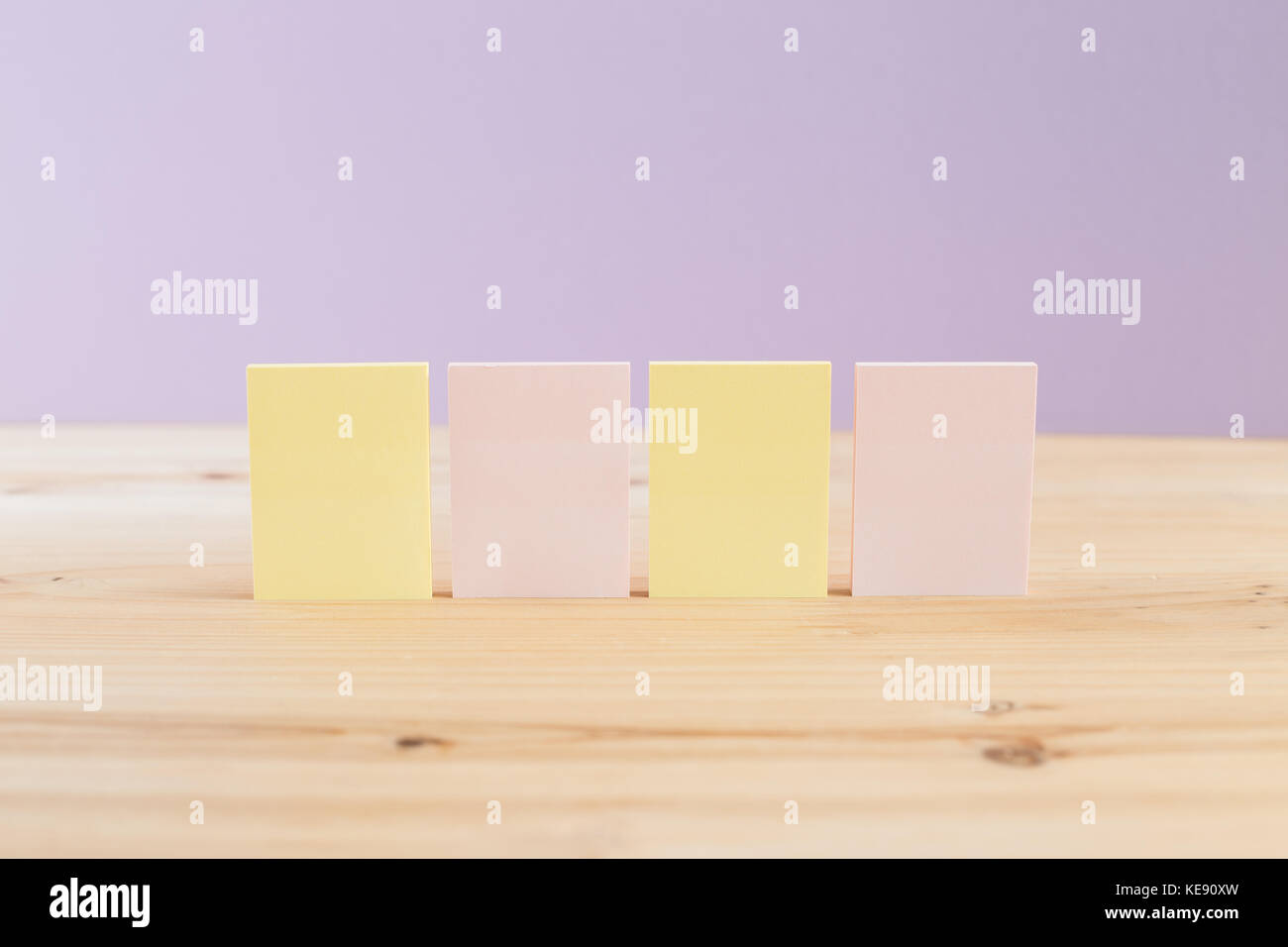 color blank sticky notes (post it) on wooden desk Stock Photo - Alamy