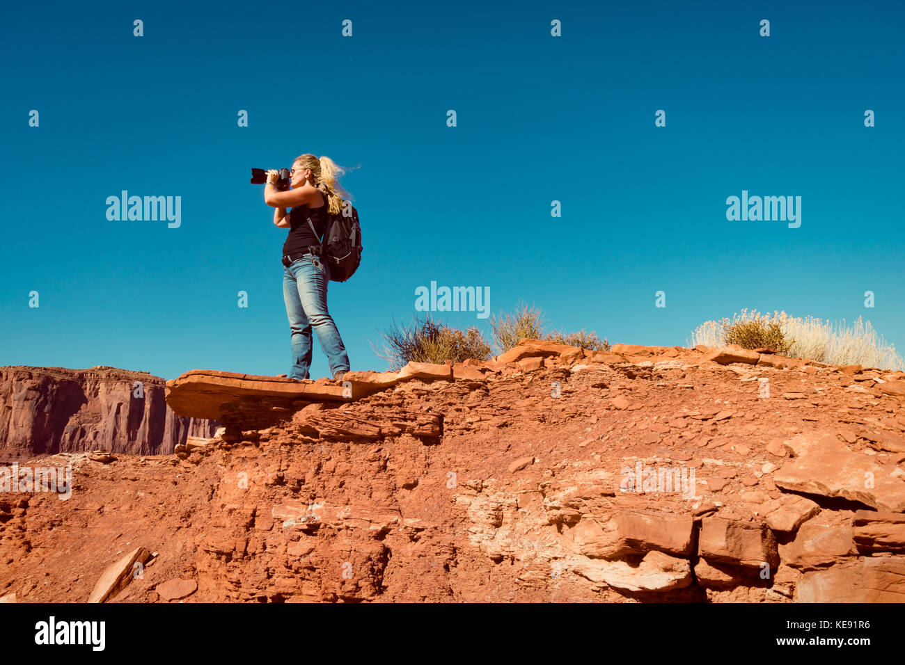 woman taking landscape photos in Arizona standing on a rock Stock Photo ...