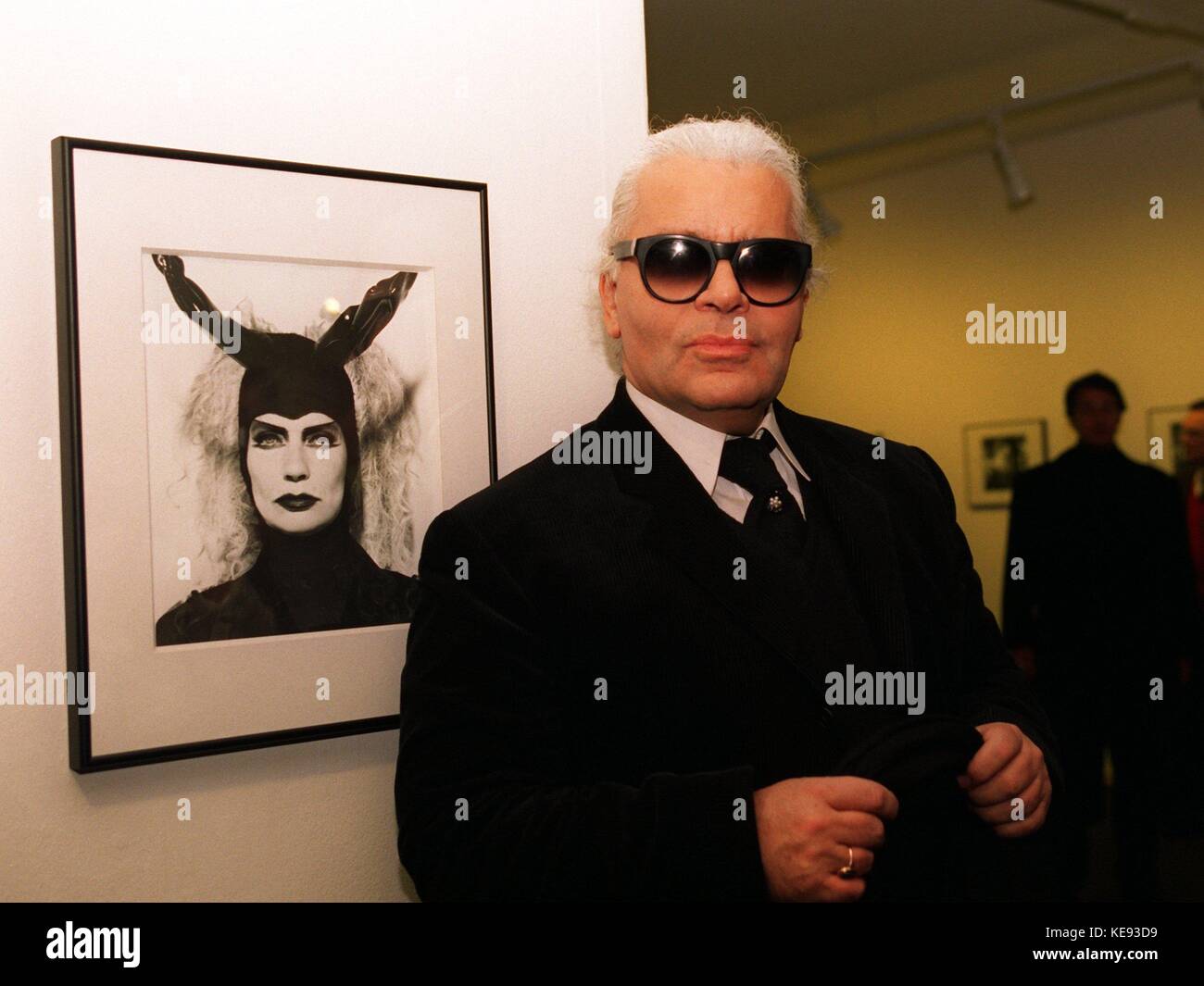 German fashion designer Karl Lagerfeld stands next to the cover picture ...