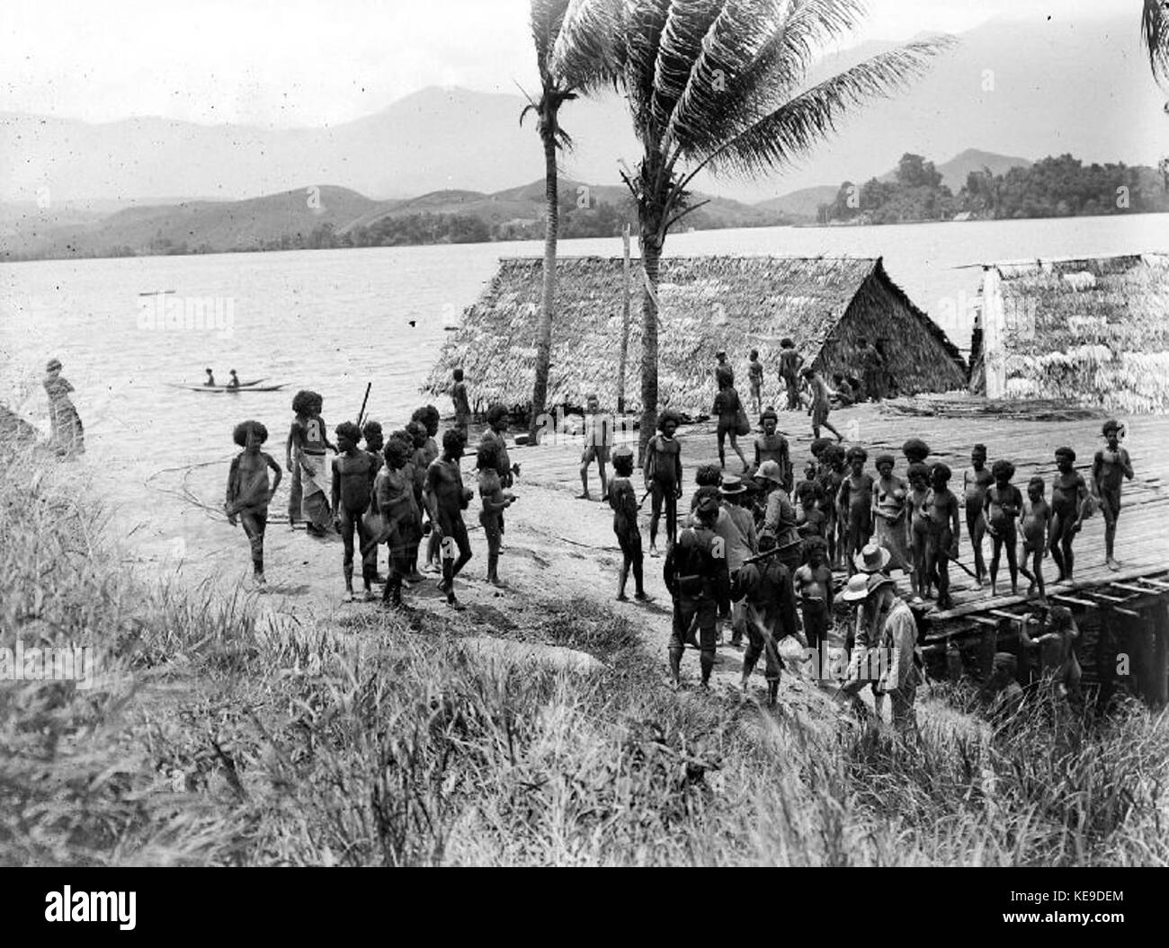 Expedition members meeting Papuan people in a village at Lake Sentani ...