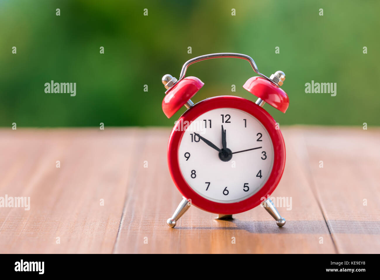 Red vintage clock on natural background. Autumn time change Stock Photo ...