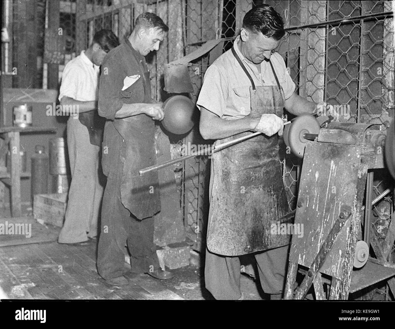 This photograph depicts the making of golf clubs at East Bros, located ...
