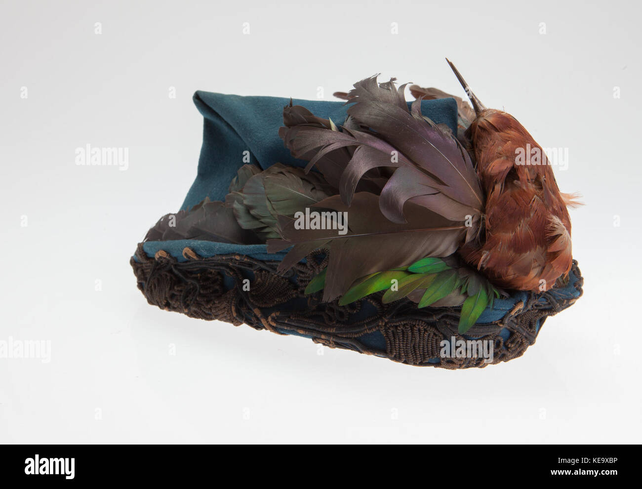 A woman's blue Robin Hood-style hat with a decorative bird perched on ...