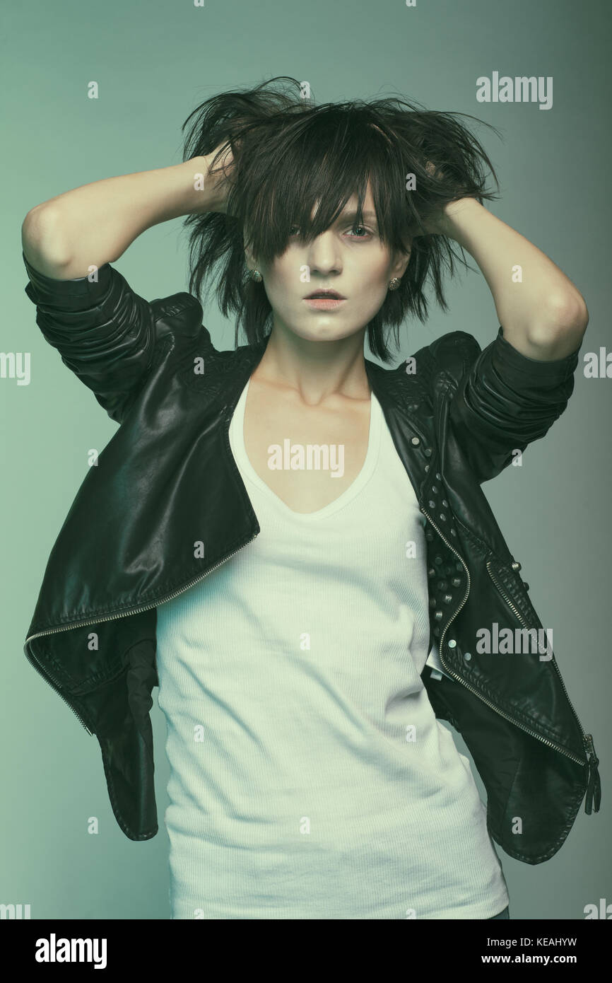 Androgyny female model in Heroin chic style. Old style tinted image ...