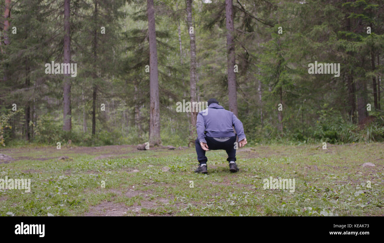 A young athletic man jumping, performs strength exercises, a crossfit ...