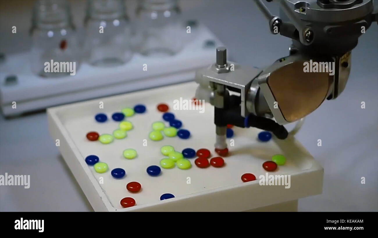 Automatic robot pharmaceutical industry. Robot automatically sorting ...