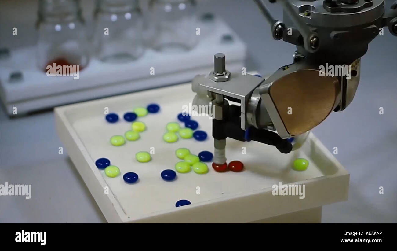 Automatic robot pharmaceutical industry. Robot automatically sorting ...