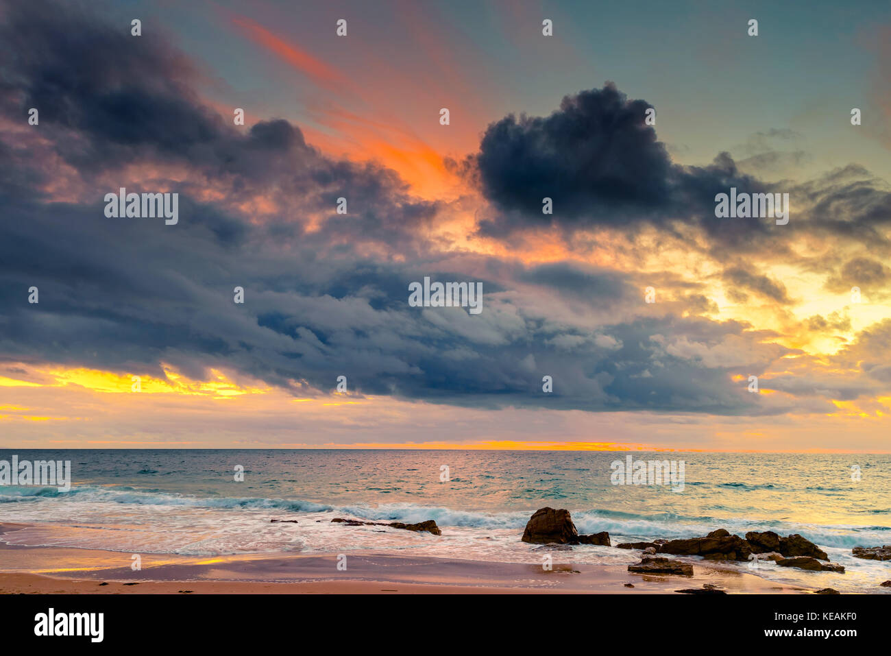 Dramatic sunset over rocky beach, South Australia Stock Photo - Alamy