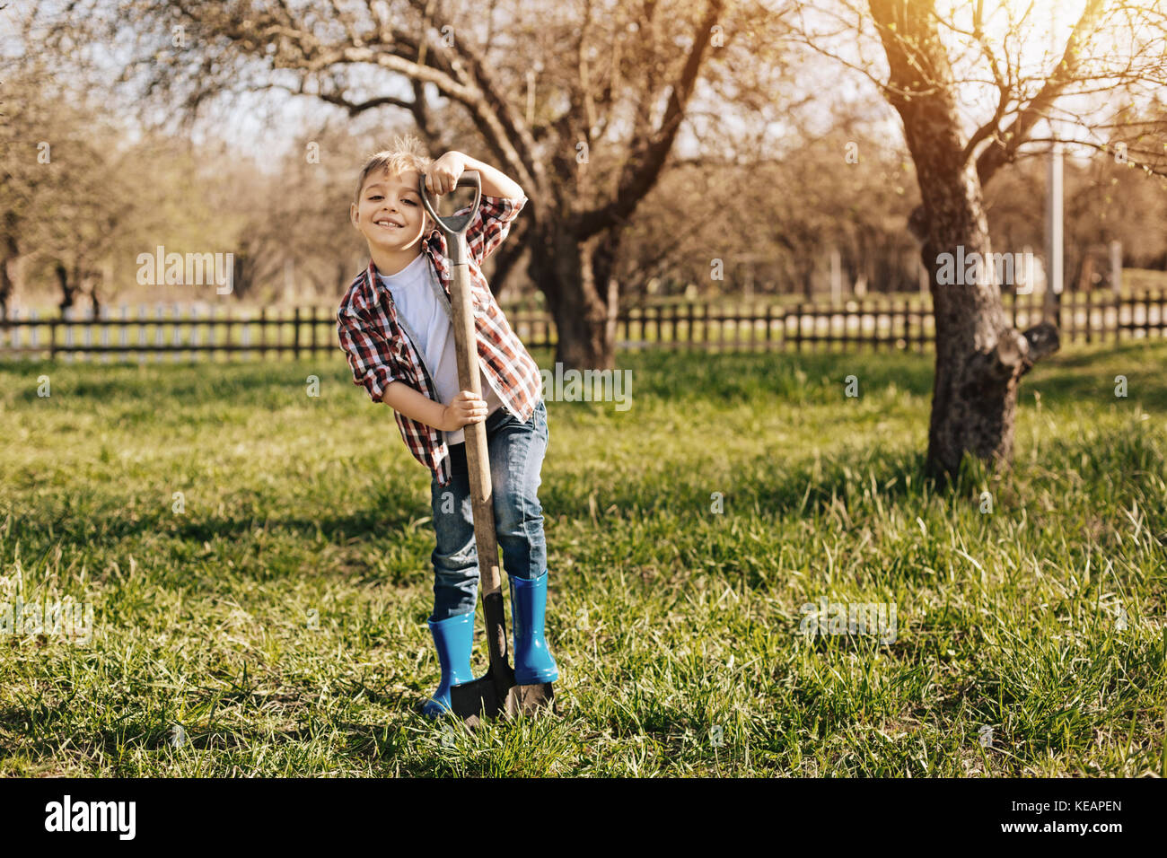 Delighted child working in the garden Stock Photo - Alamy