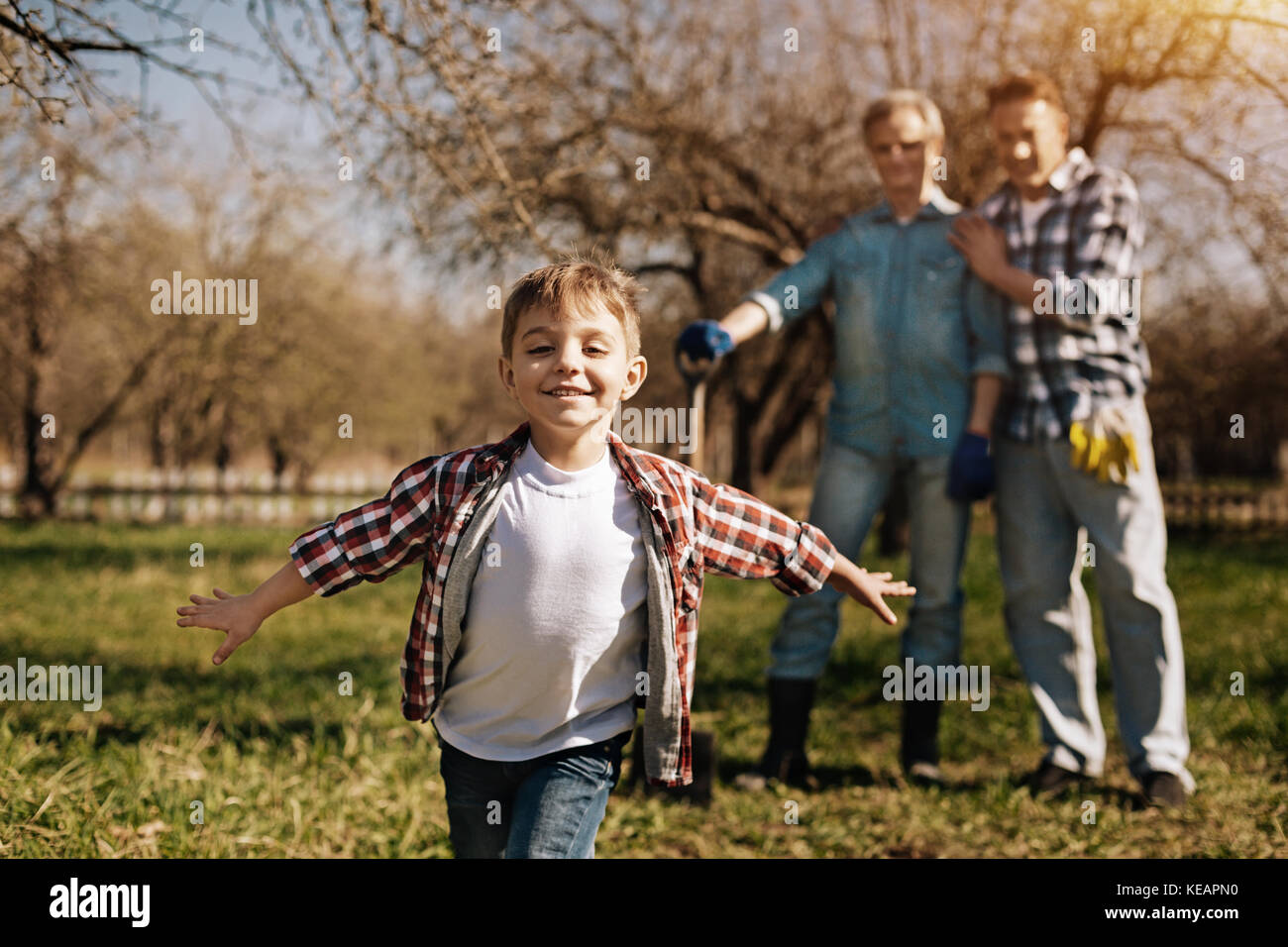 Delighted kid running around garden Stock Photo - Alamy