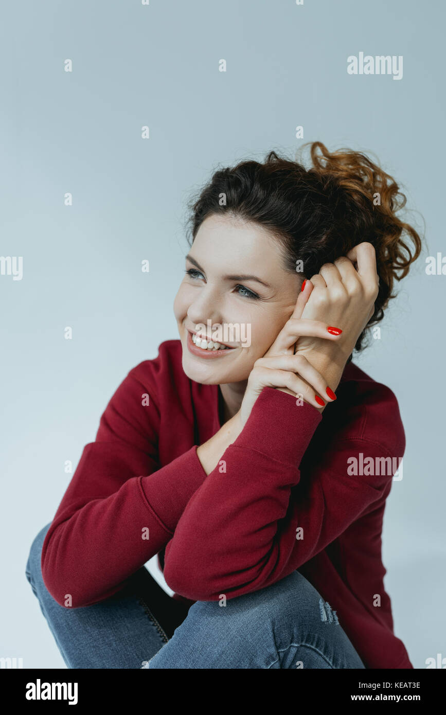 cheerful pretty woman posing in photo studio, isolated on grey Stock ...