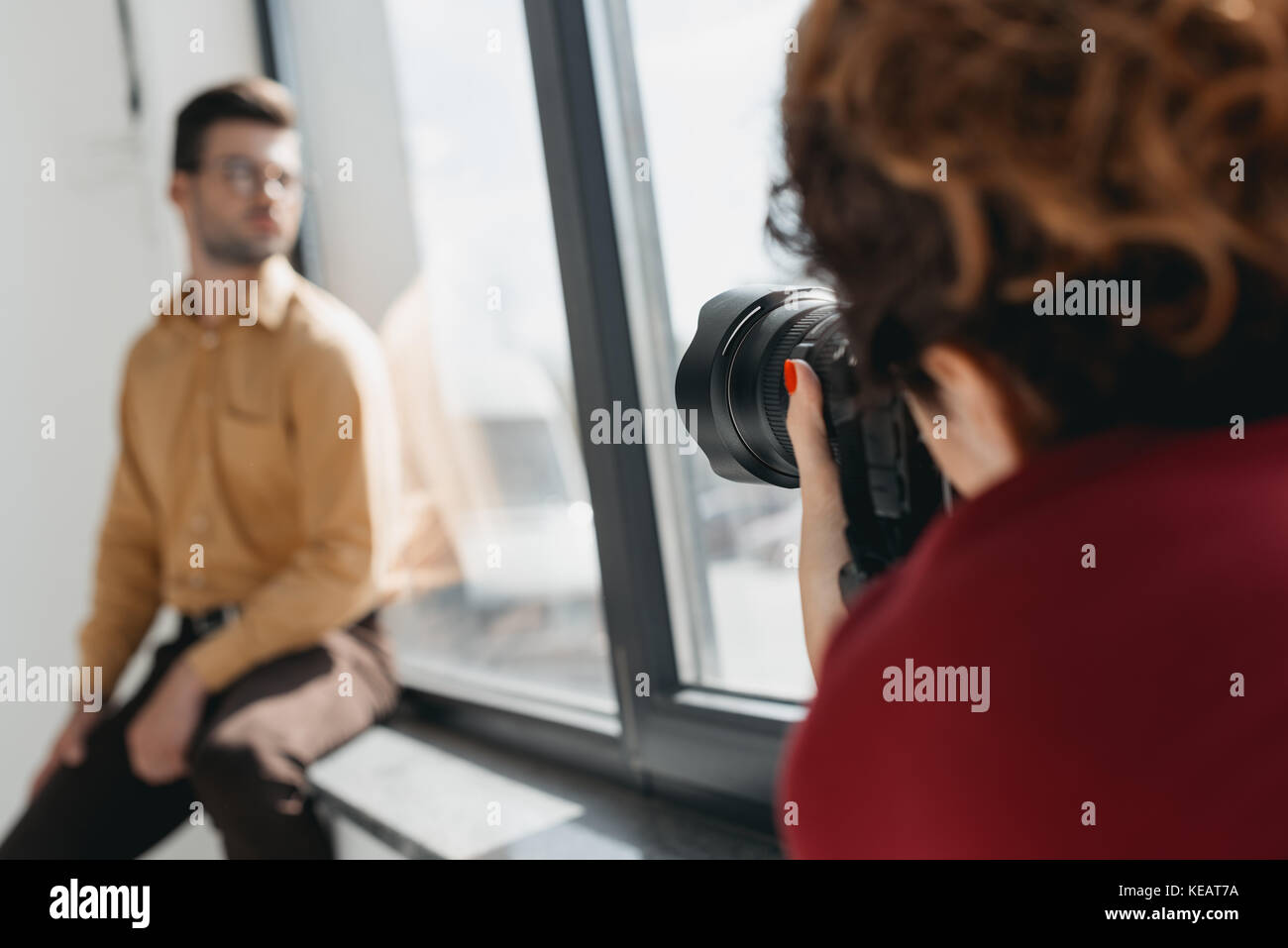 photographer and model at window Stock Photo - Alamy