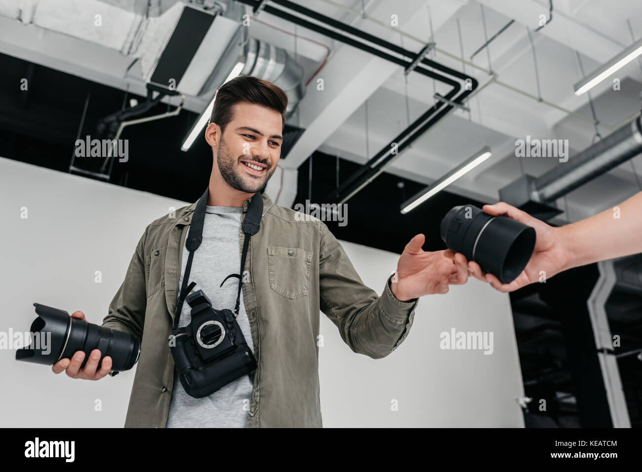 photographer with camera and lenses Stock Photo - Alamy