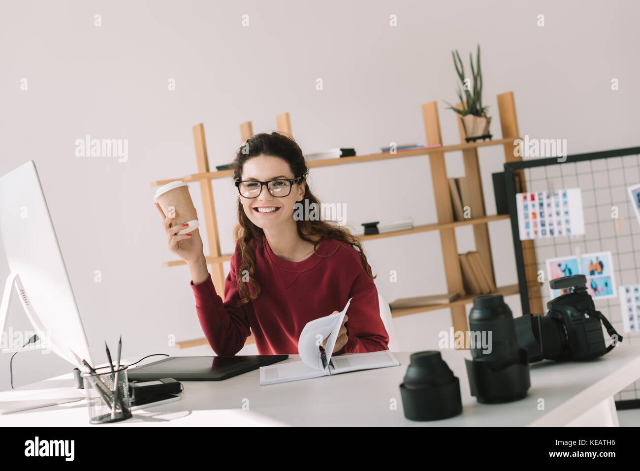 photographer working in office Stock Photo - Alamy