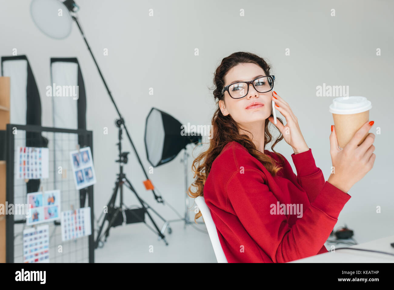 designer with smartphone in office Stock Photo - Alamy