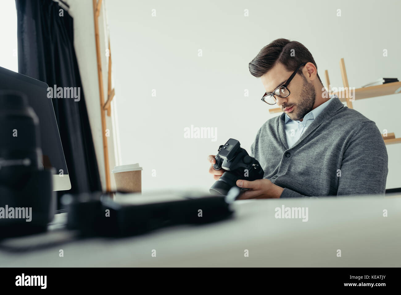 photographer working in modern office Stock Photo - Alamy
