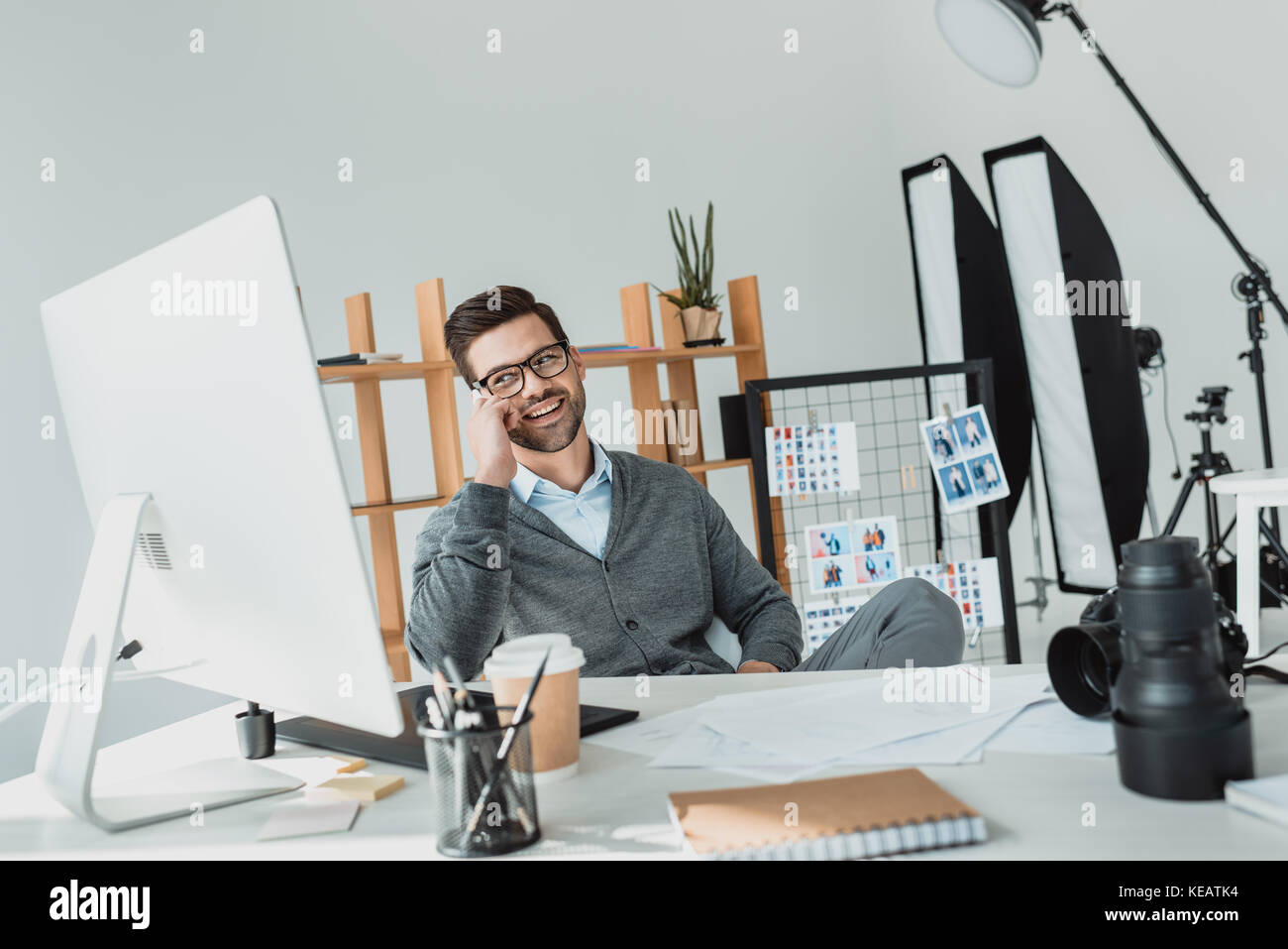 photographer working in office Stock Photo - Alamy