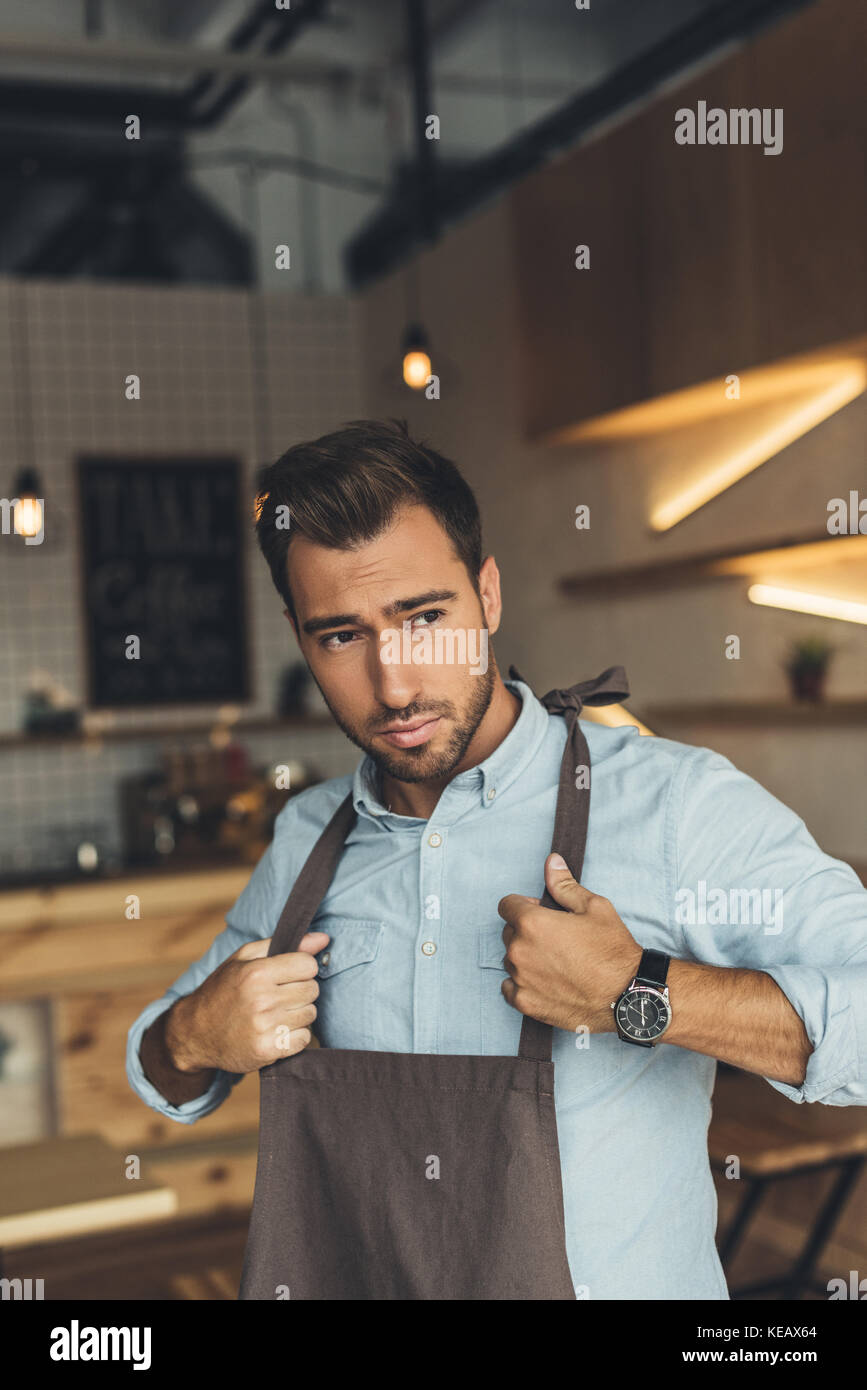 worker wearing apron Stock Photo - Alamy