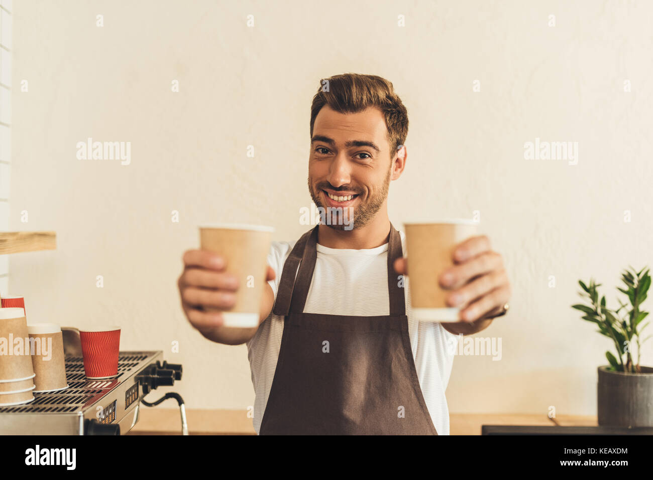 barista showing coffee to go Stock Photo - Alamy