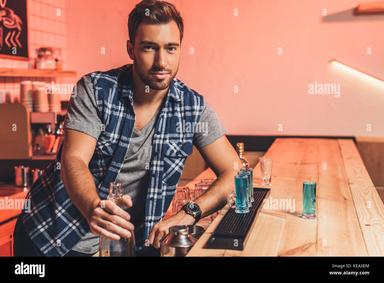 barman with alcohol shots on counter Stock Photo - Alamy