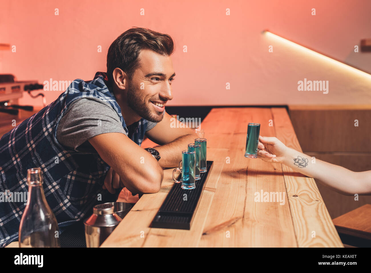 barman with alcohol shots on counter Stock Photo - Alamy