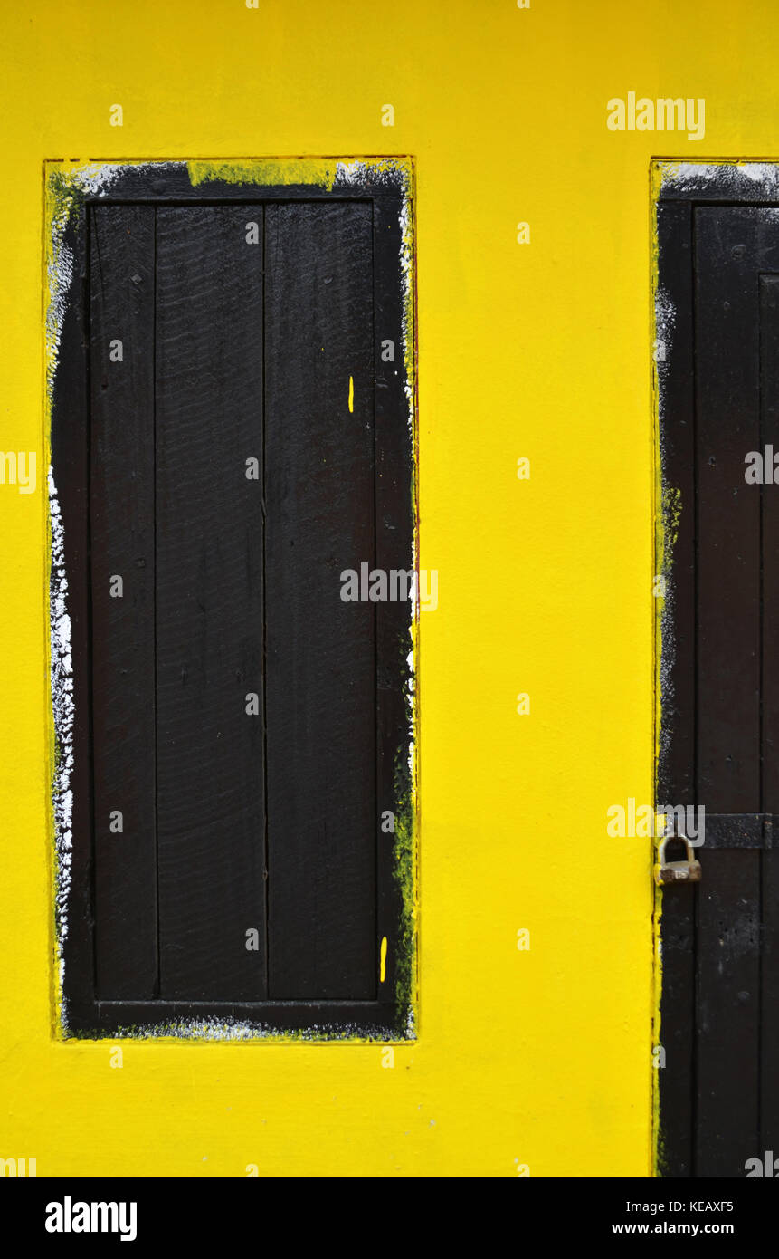 Wooden window with yellow wall Stock Photo - Alamy