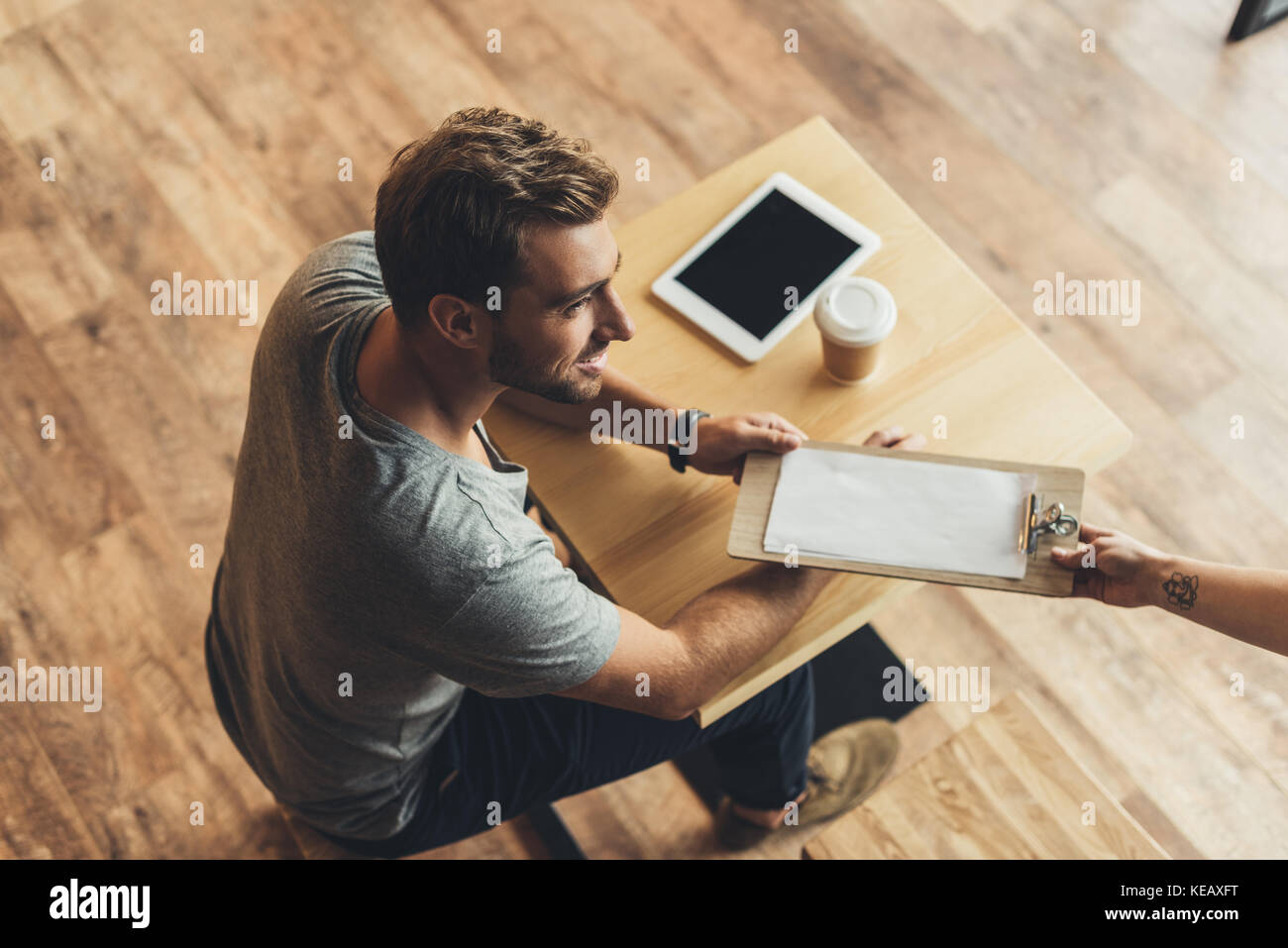 man giving menu to waitress Stock Photo - Alamy