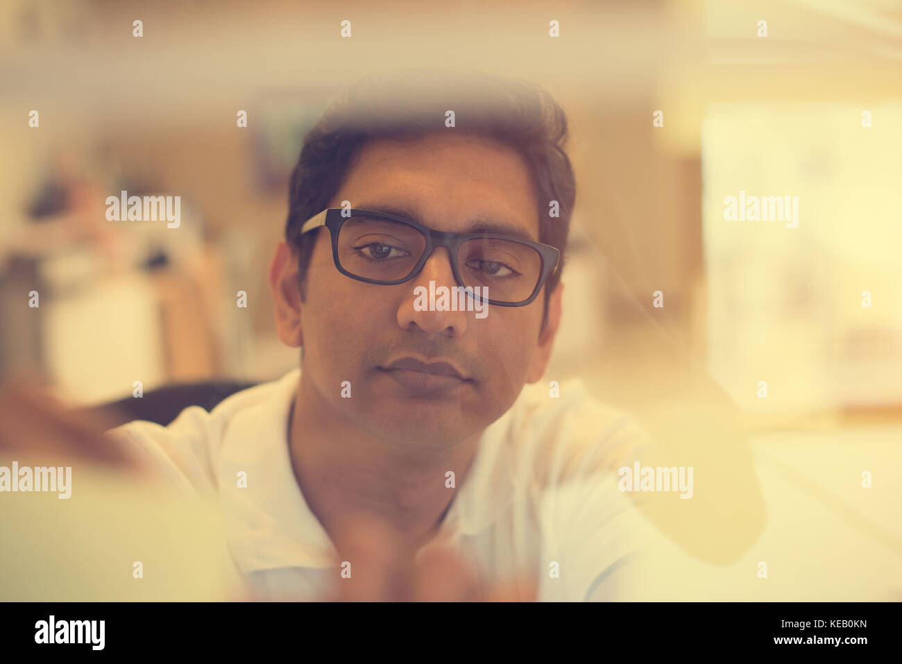 indian business male writing glass wall Stock Photo - Alamy