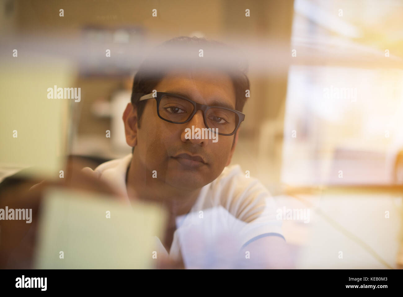 indian business male writing glass wall Stock Photo - Alamy