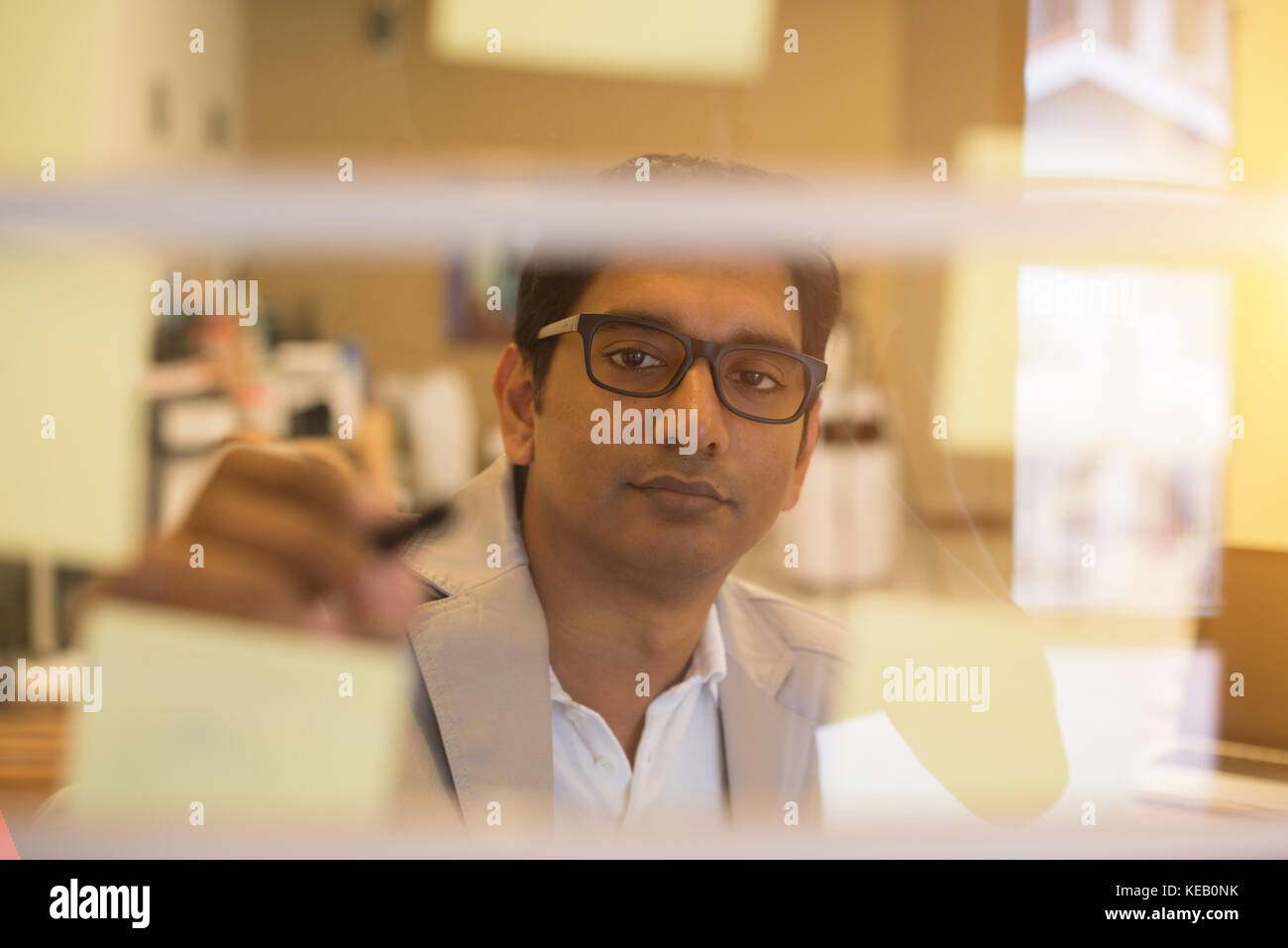 indian business male writing glass wall Stock Photo - Alamy