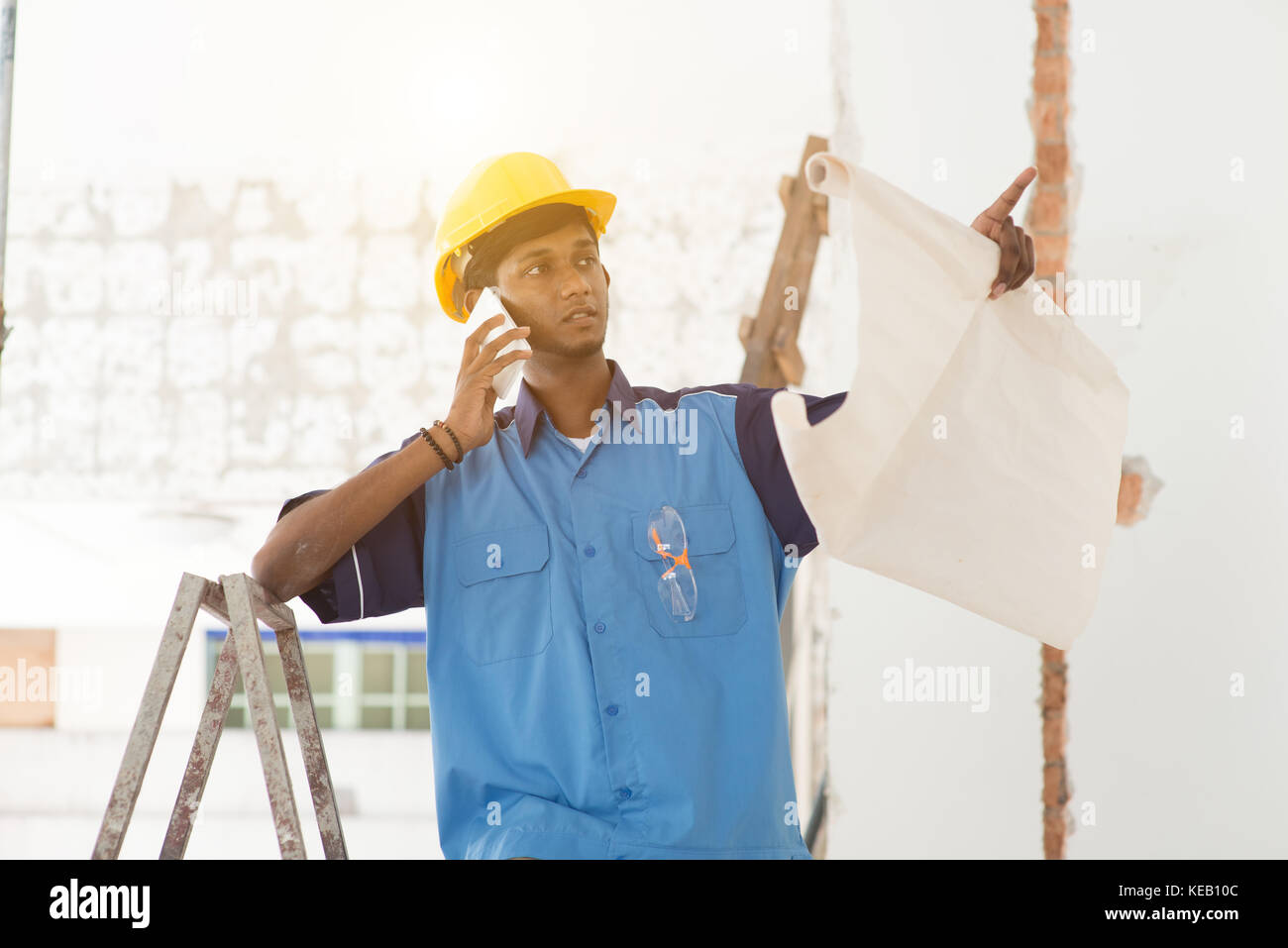 indian male construction worker using phone Stock Photo - Alamy