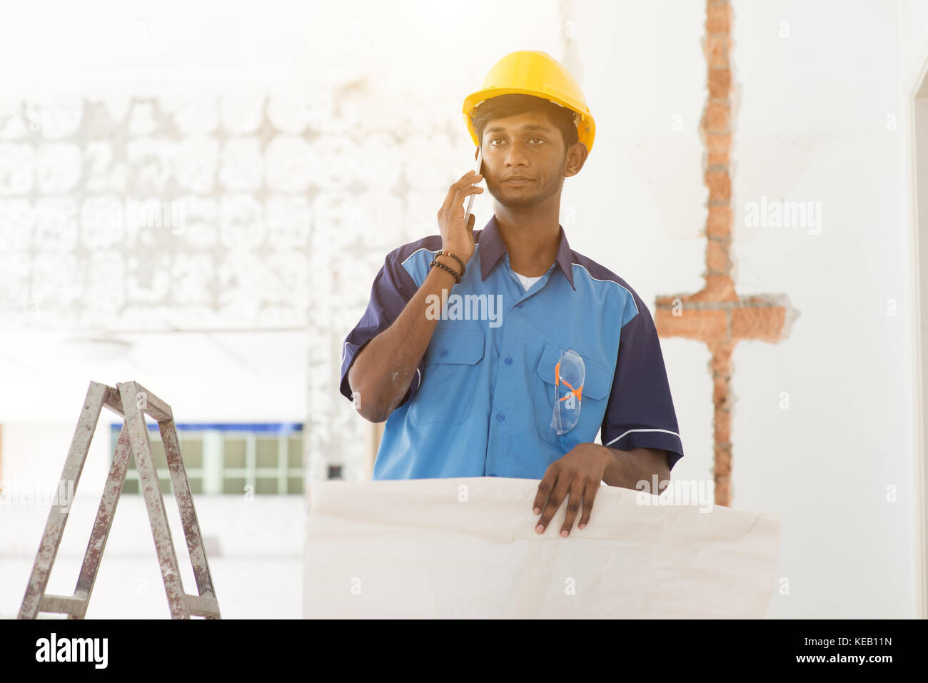 indian male construction worker using phone Stock Photo - Alamy