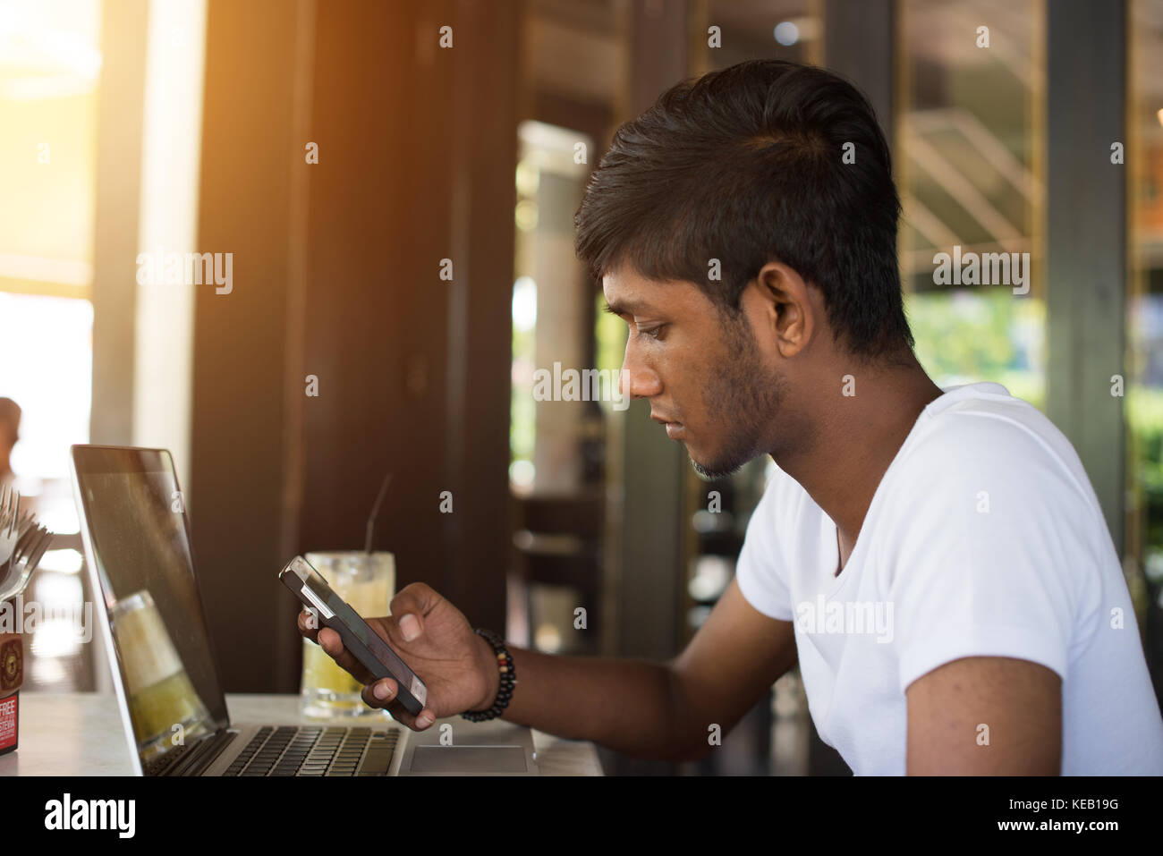 indian teenage using phone at cafe Stock Photo - Alamy