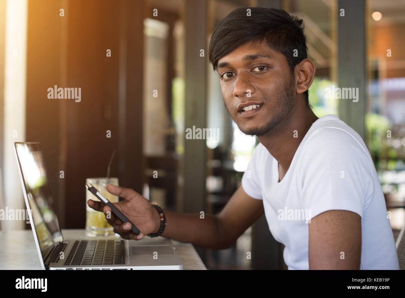 indian teenage using phone at cafe Stock Photo - Alamy