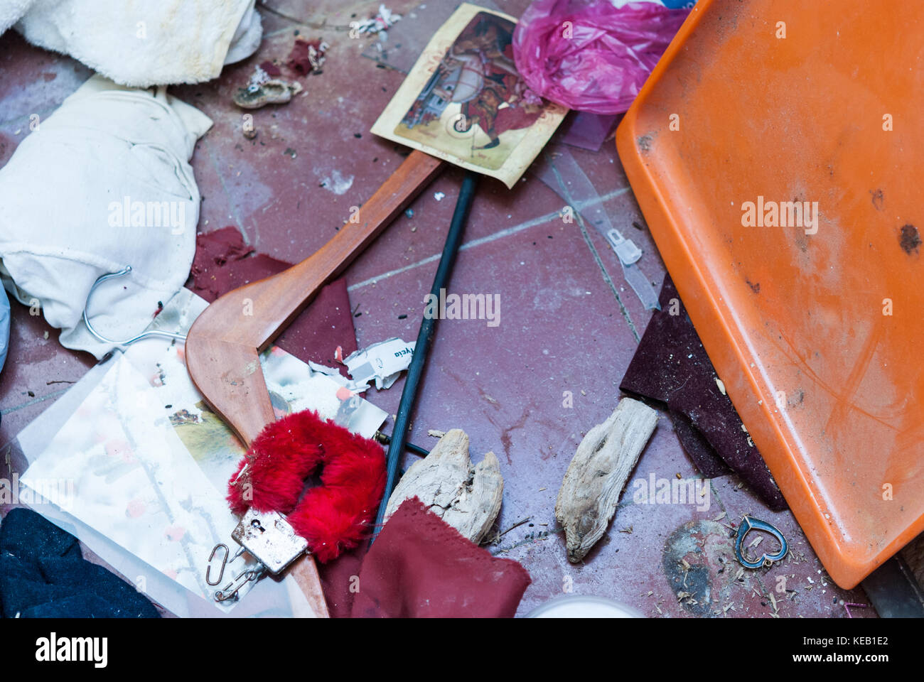 Abandoned home interior with objects on the floor - clothes and ...