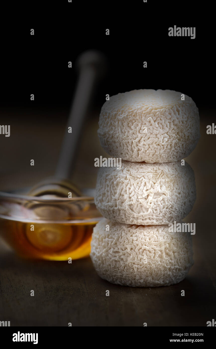 French fresh goat cheese called crottin de chavignol and honey Stock ...