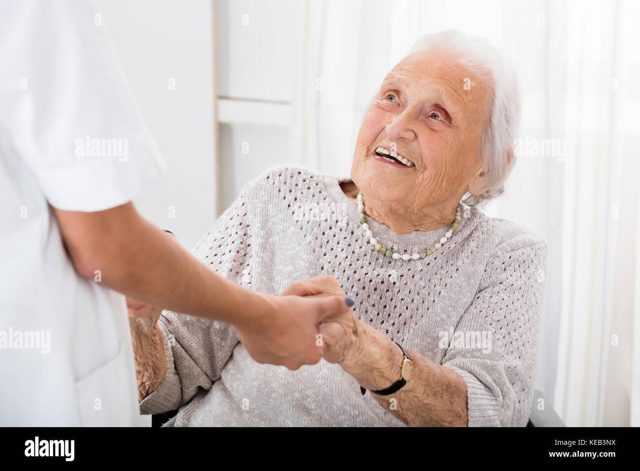Caregiver hands hi-res stock photography and images - Alamy