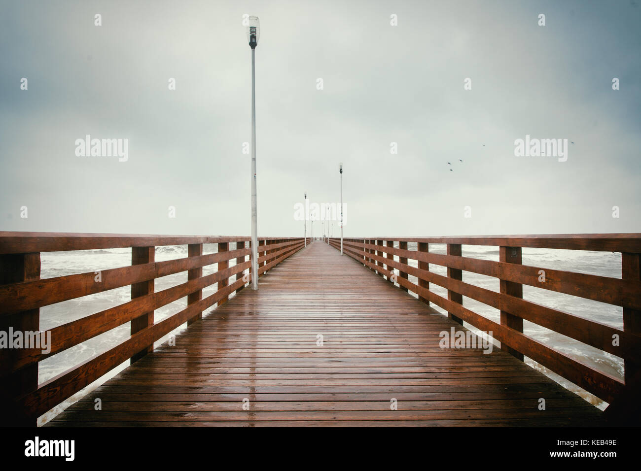 Long wooden pier at the sea Stock Photo - Alamy