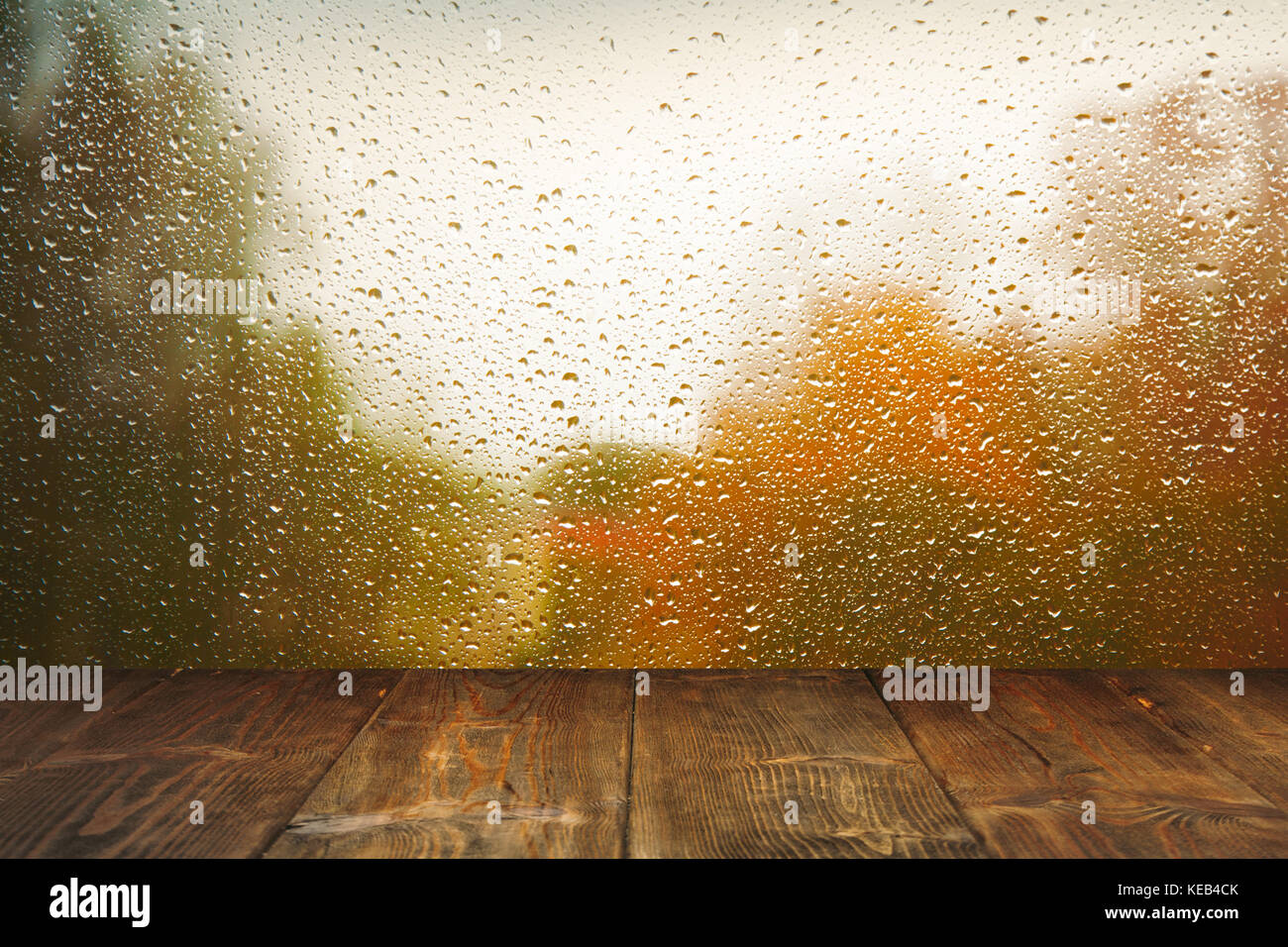 Table on rainy window background Stock Photo - Alamy