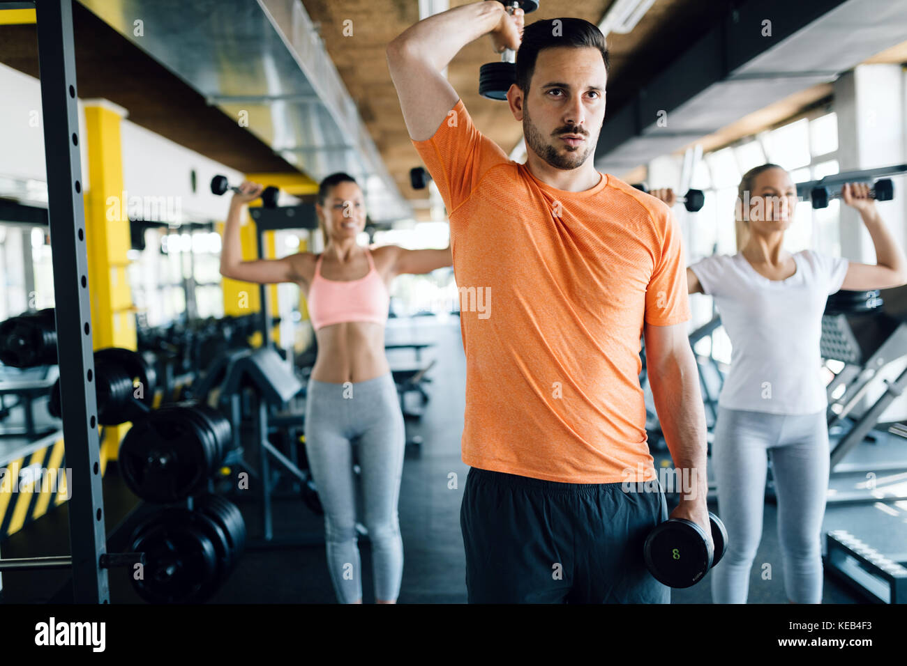 Group of friends exercising together in gym Stock Photo - Alamy