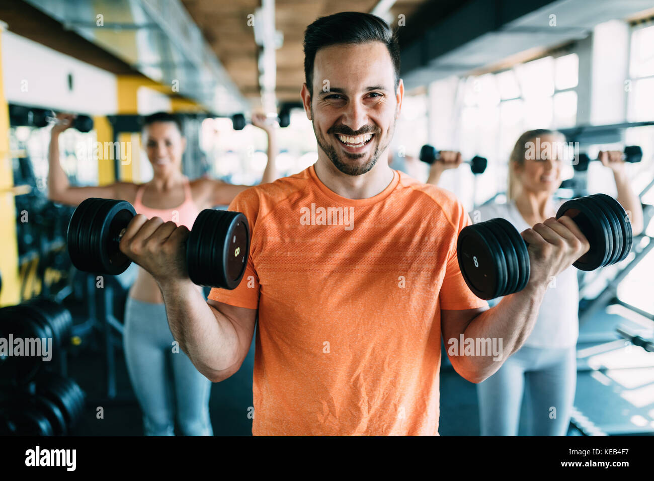 Young attractive man doing exercises in gym Stock Photo - Alamy