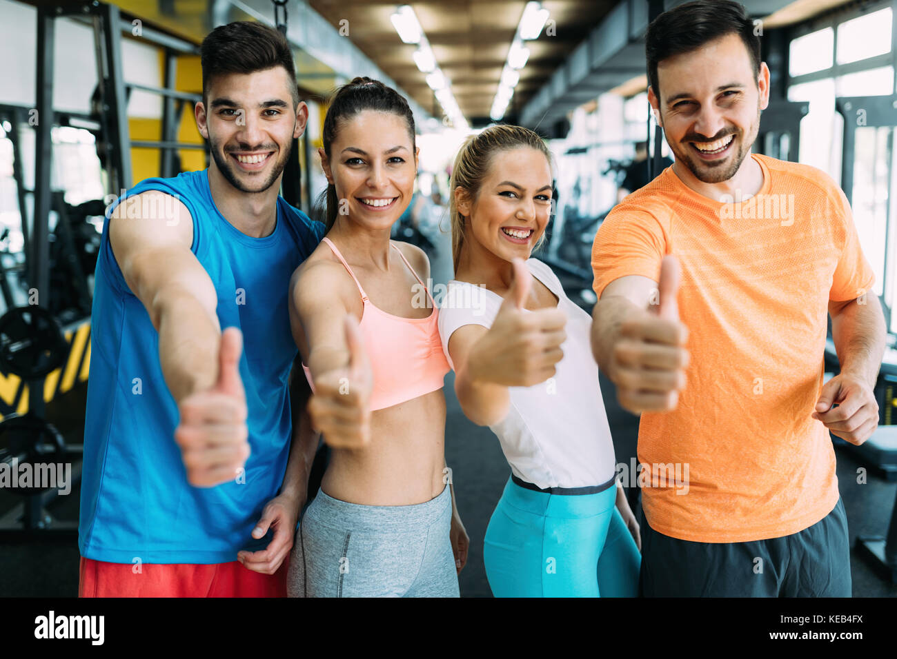 Picture of cheerful fitness team in gym Stock Photo - Alamy
