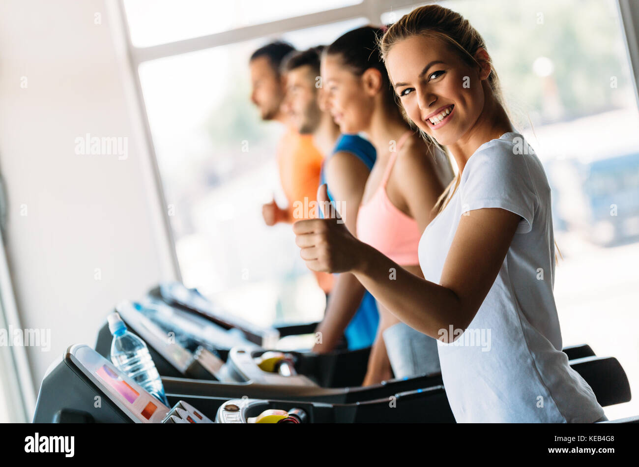 Group of friends exercising on treadmill machine Stock Photo - Alamy