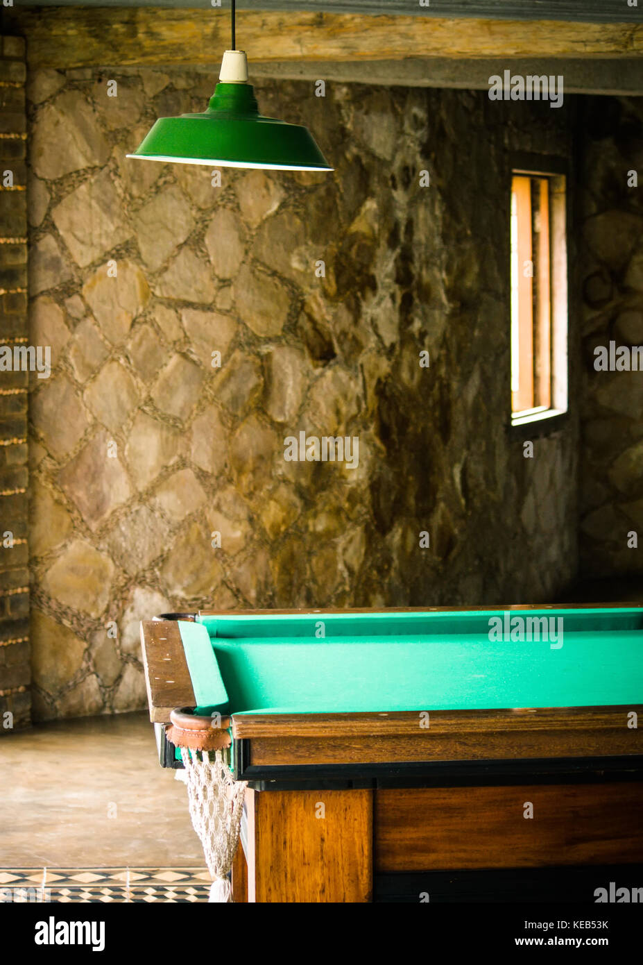 Detail of games room with snooker billiards table, stonewall, green ...