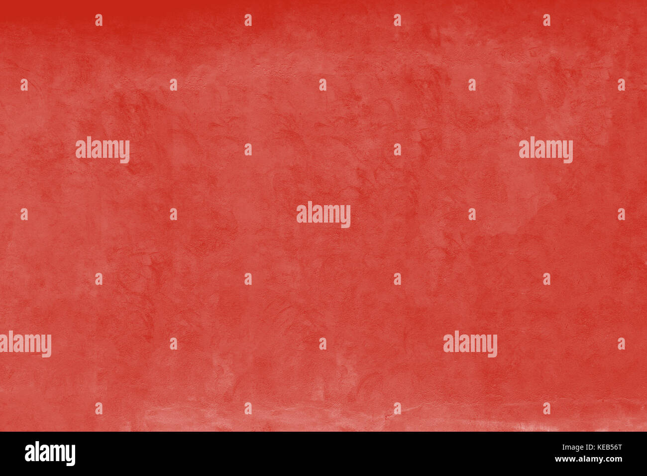Vivid red color coarse facade wall as an empty rustic background ...
