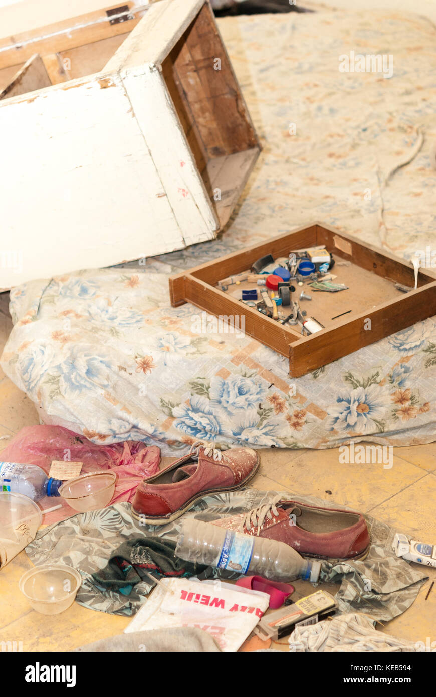 Abandoned home interior with objects on the floor - clothes and ...