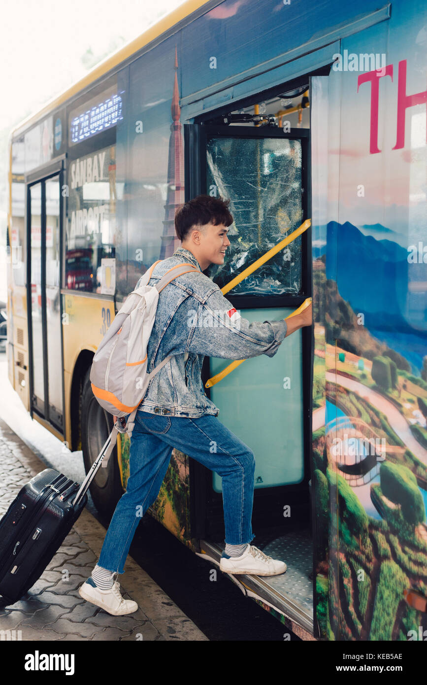 Asian male young traveler getting on the tourist bus for travel Stock ...